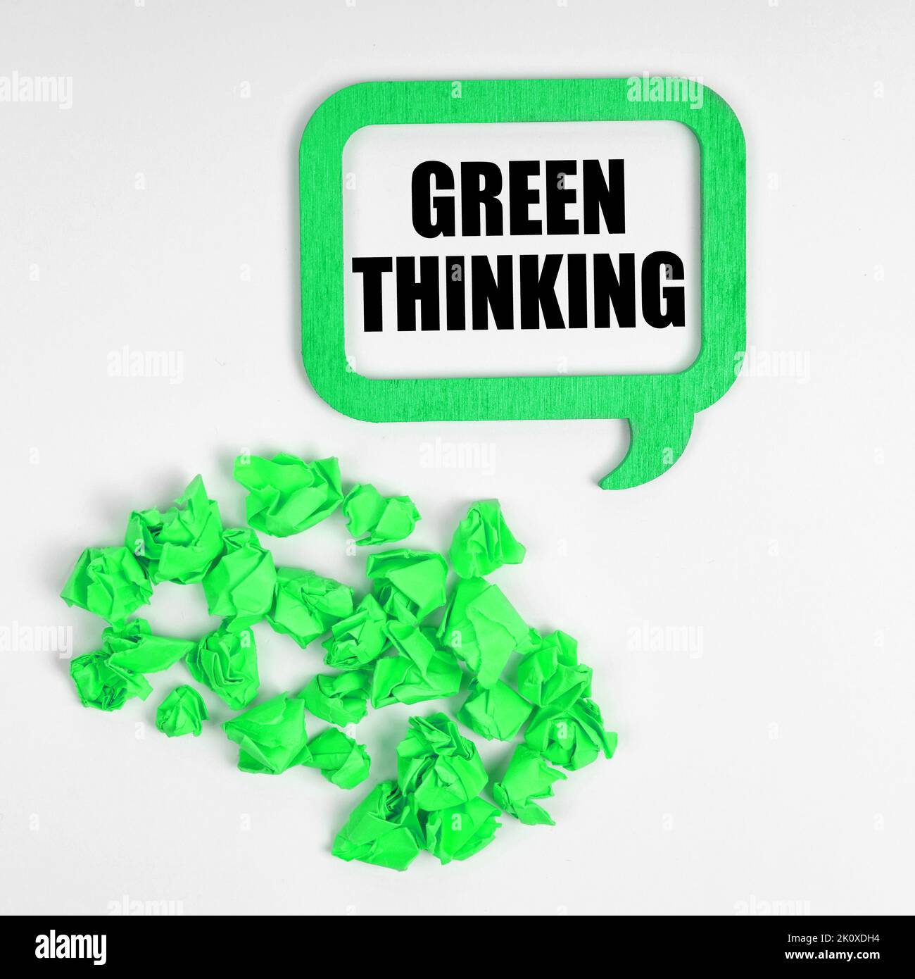 Ecology concept. On a white background, green crumpled pieces of paper ...