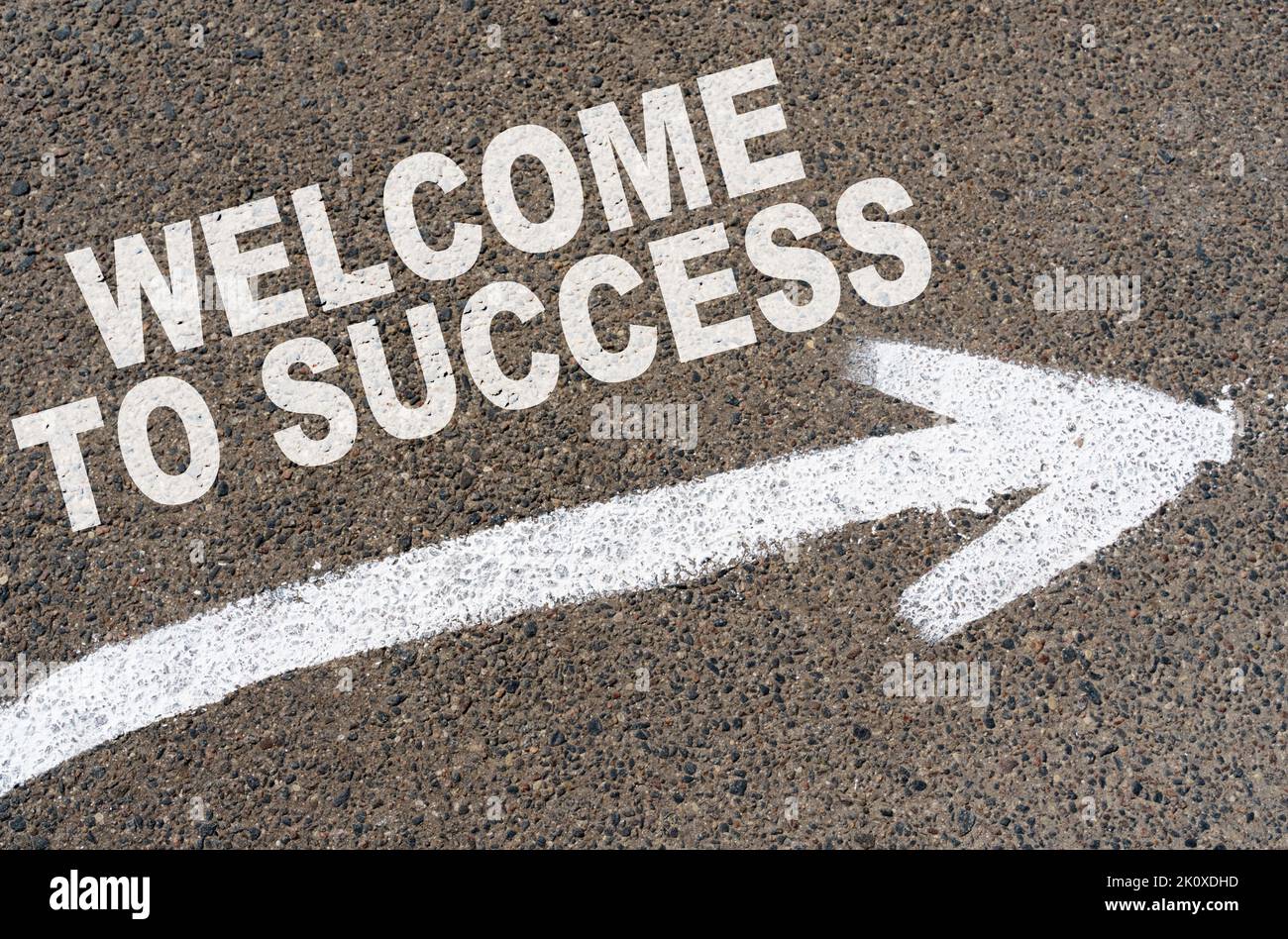 Business concept. On the asphalt road markings an arrow with the ...