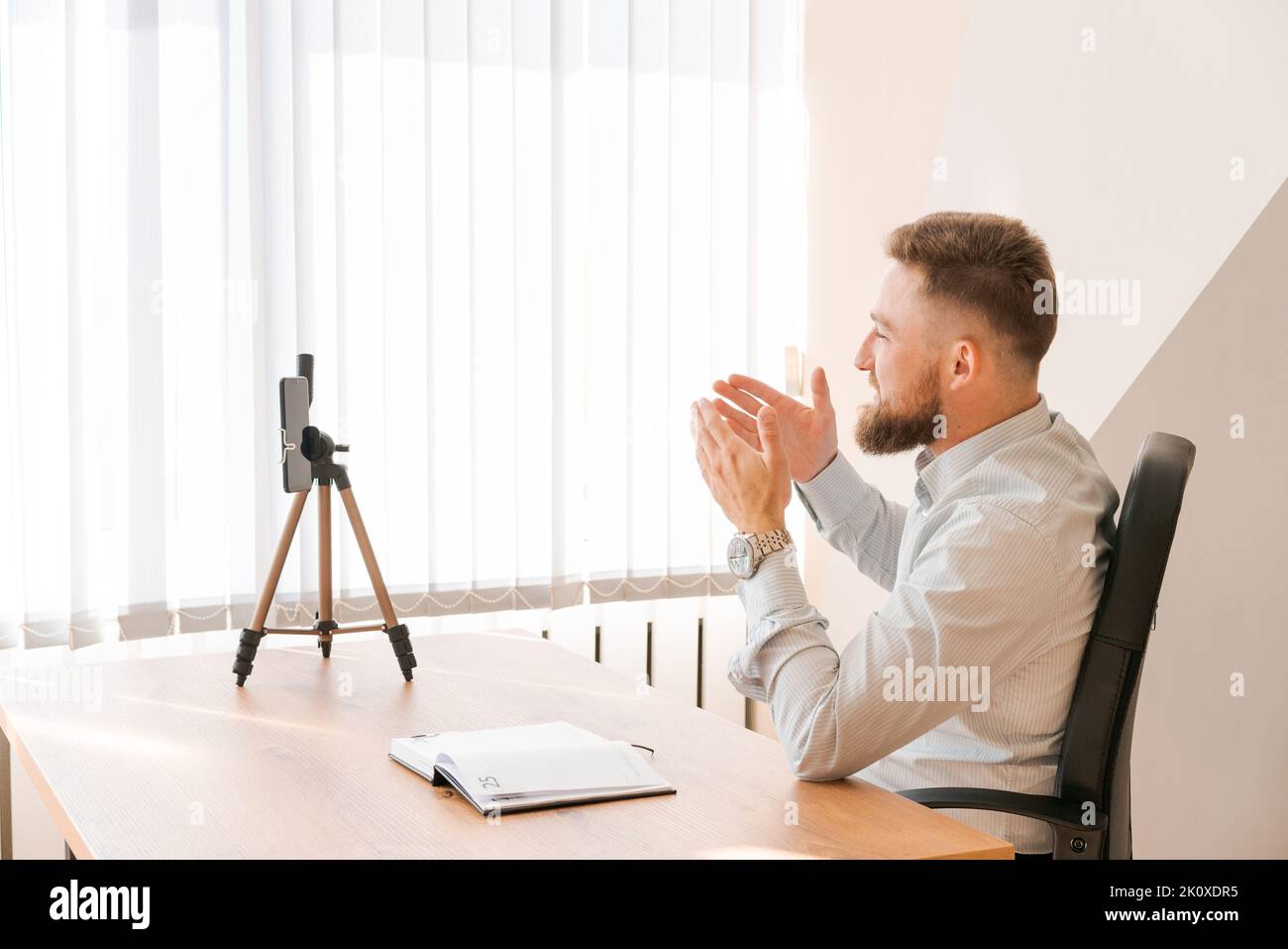 Smiling bearded business man, filming his video blog episode using ...
