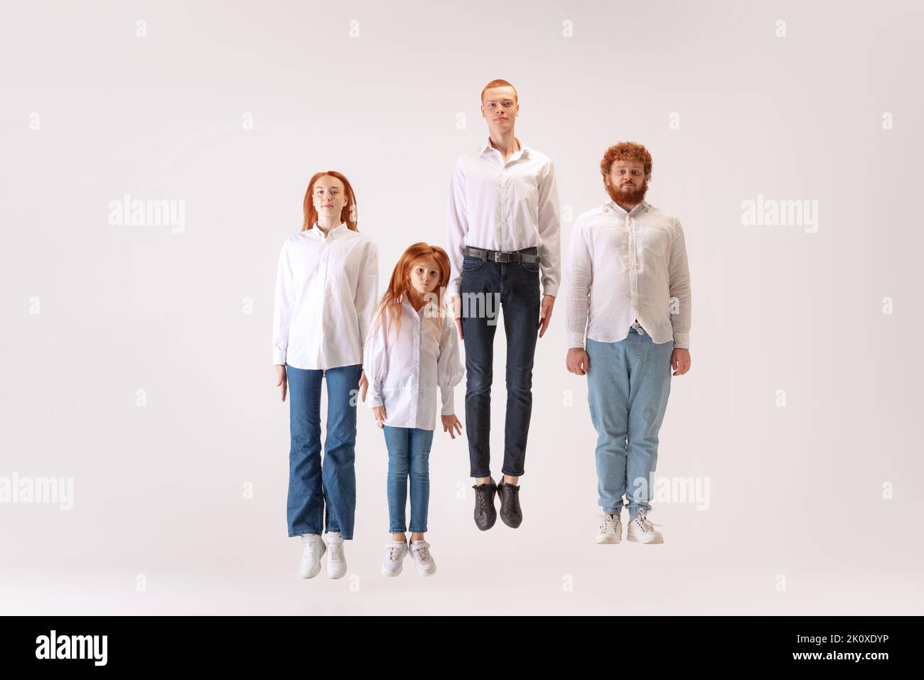 Flying. Two men and woman and kid, red-headed young people wearing ...