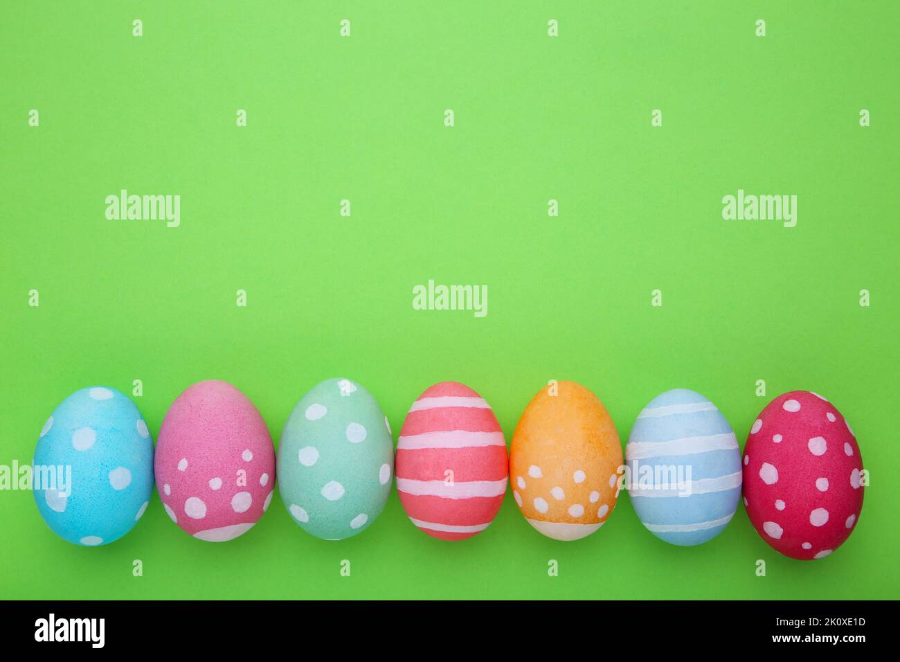 Colorful easter eggs on a green background Stock Photo - Alamy