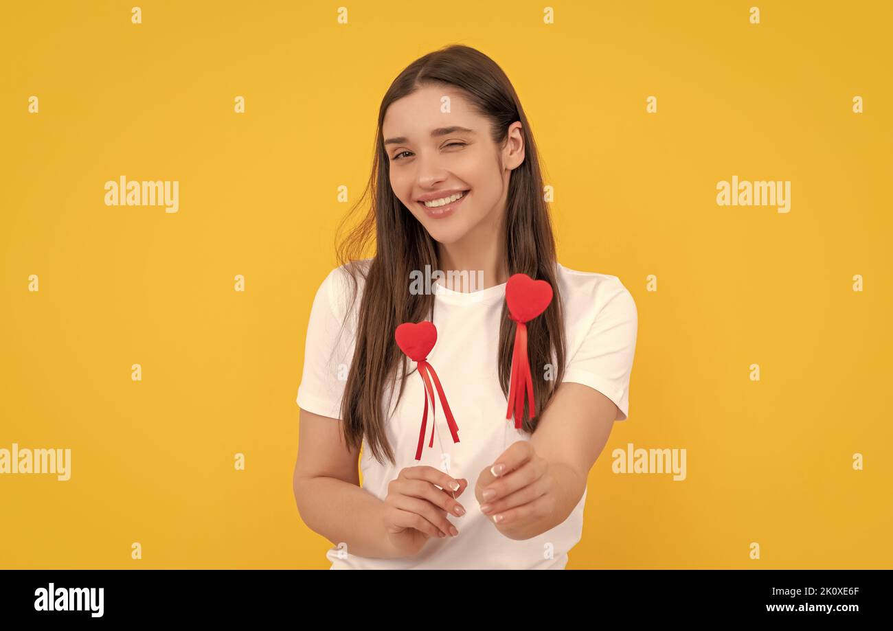 happy lady in white shirt with heart on yellow background, valentines ...
