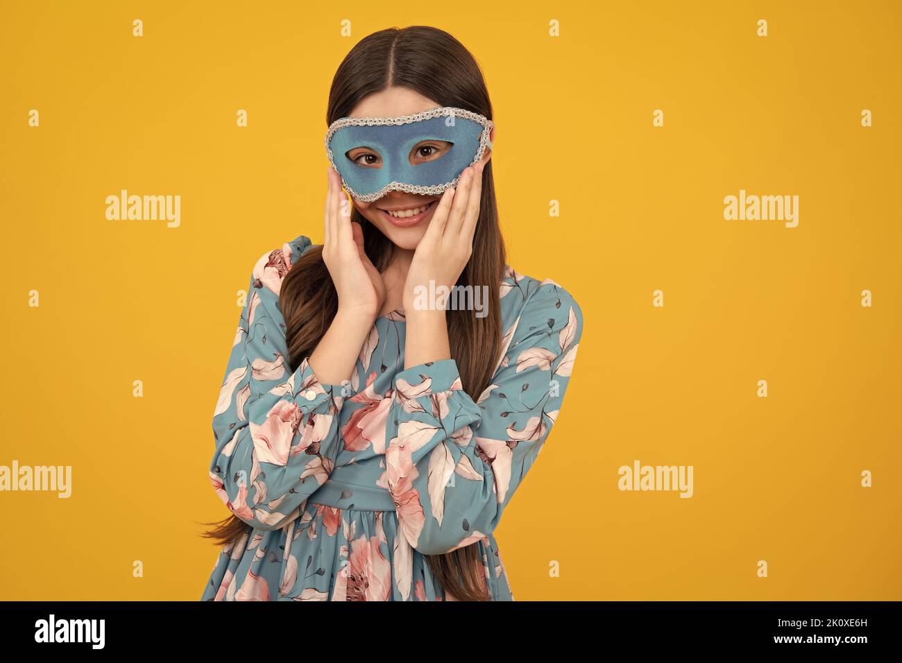 Teenager child girl in samba mask at carnival isolated on yellow ...