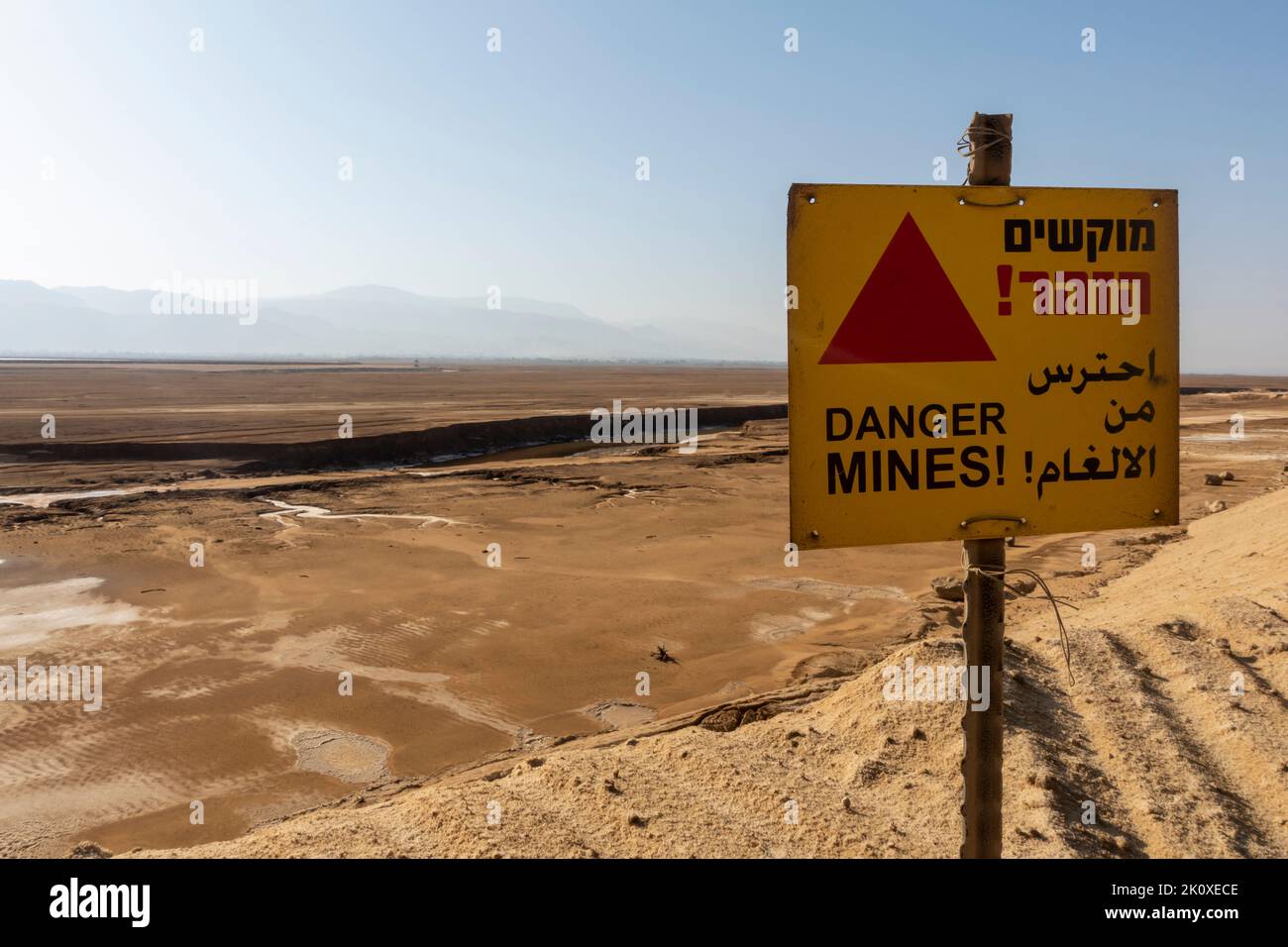 A minefield warning sign placed at the site of a salt wall barrier ...