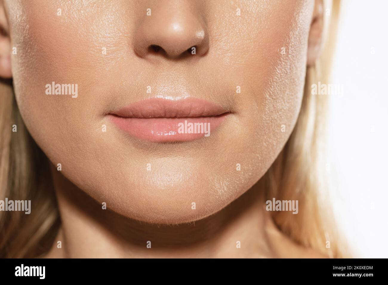 Closeup of female lips, cheeks and nose isolated over white studio ...
