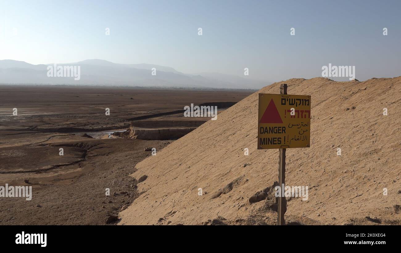 A minefield warning sign placed at the site of a salt wall barrier ...