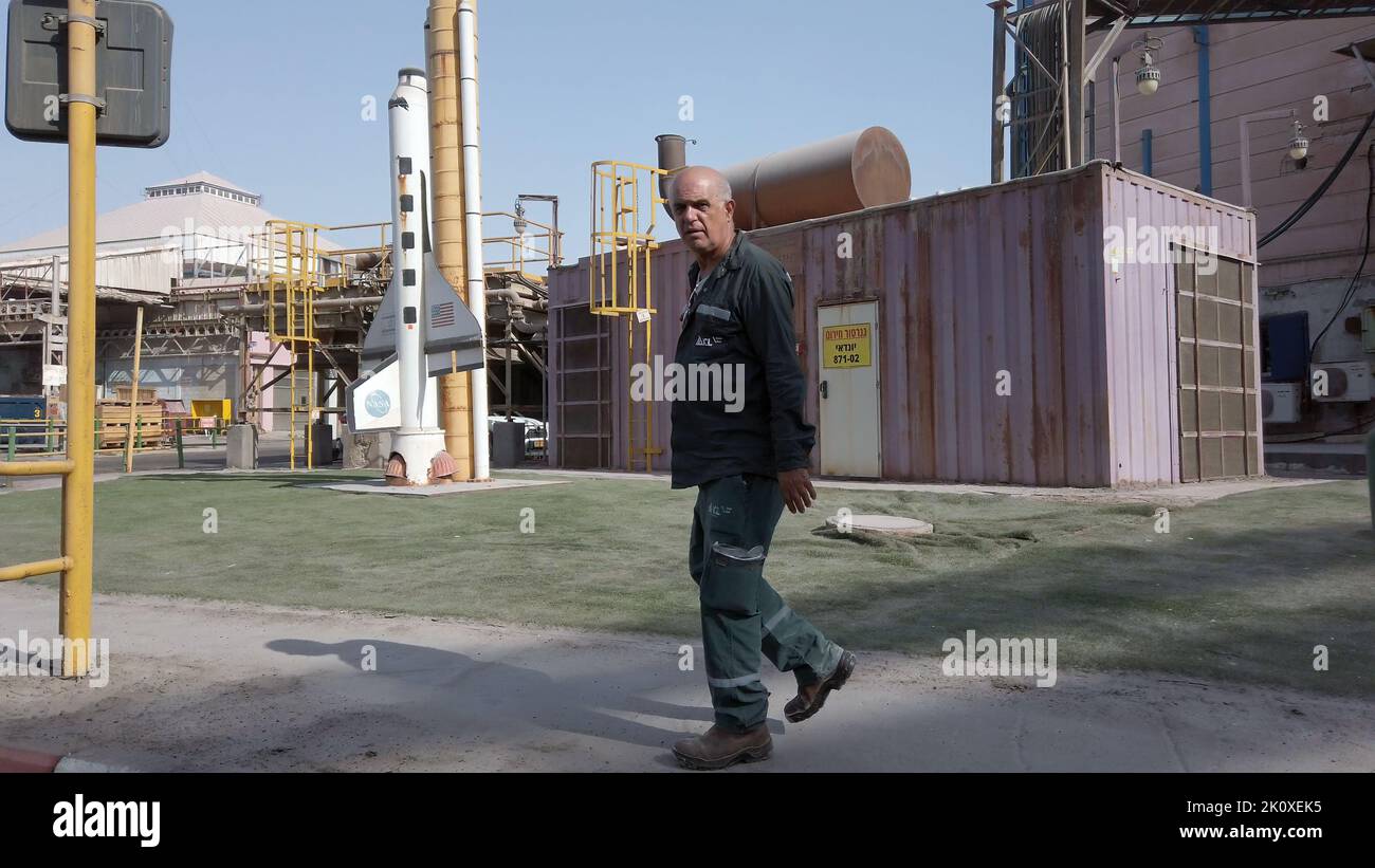 A worker walks at the 'Dead Sea Works' potash plant, part of the ...