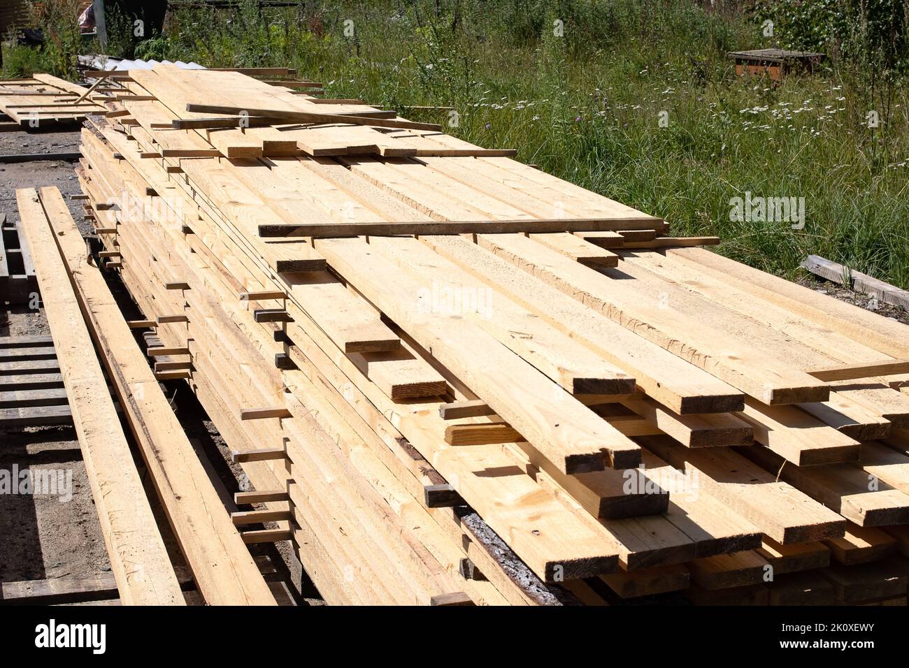 Folded finished boards at the sawmill close up Stock Photo - Alamy