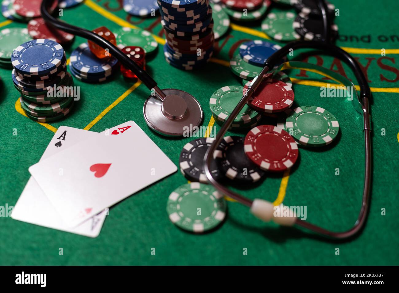 poker chips, money, stethoscope on blackjack table Stock Photo - Alamy