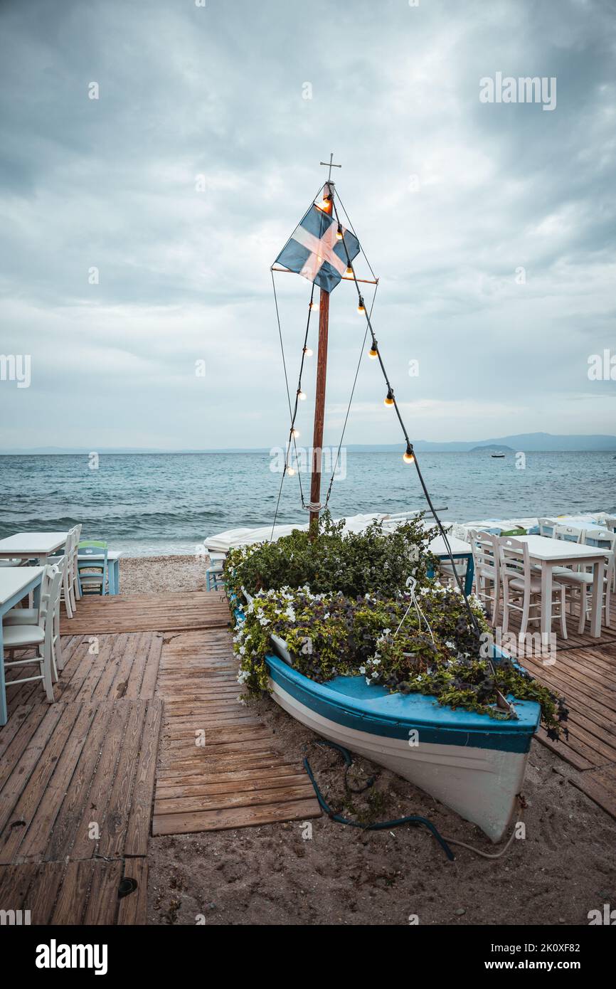 a vertical shot of a blue boat decoration on a beach cafe Stock Photo ...