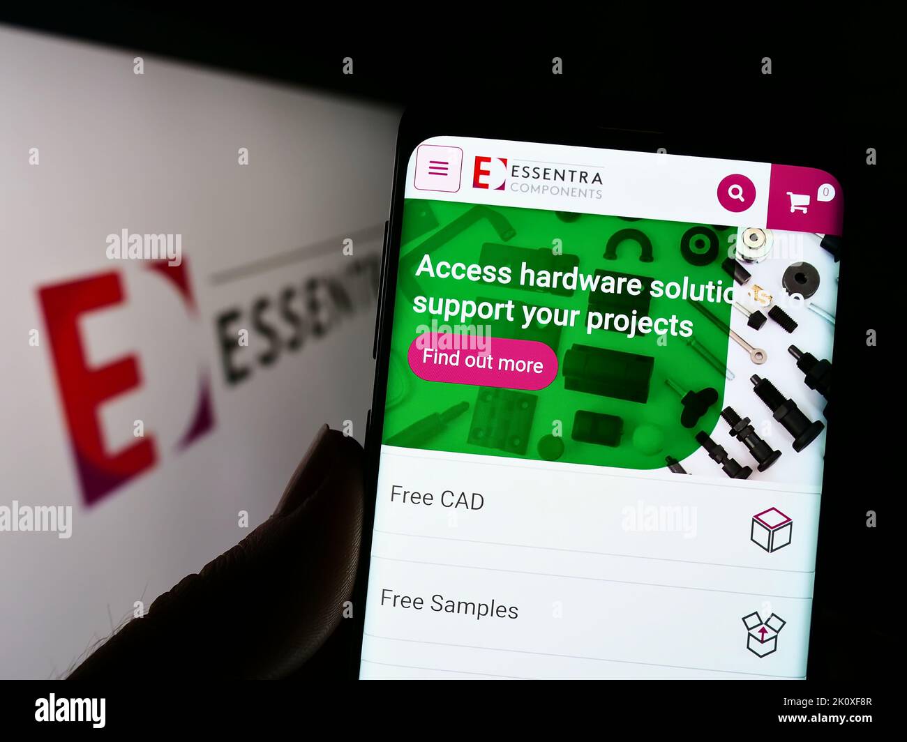 Person holding cellphone with website of British manufacturing company ...