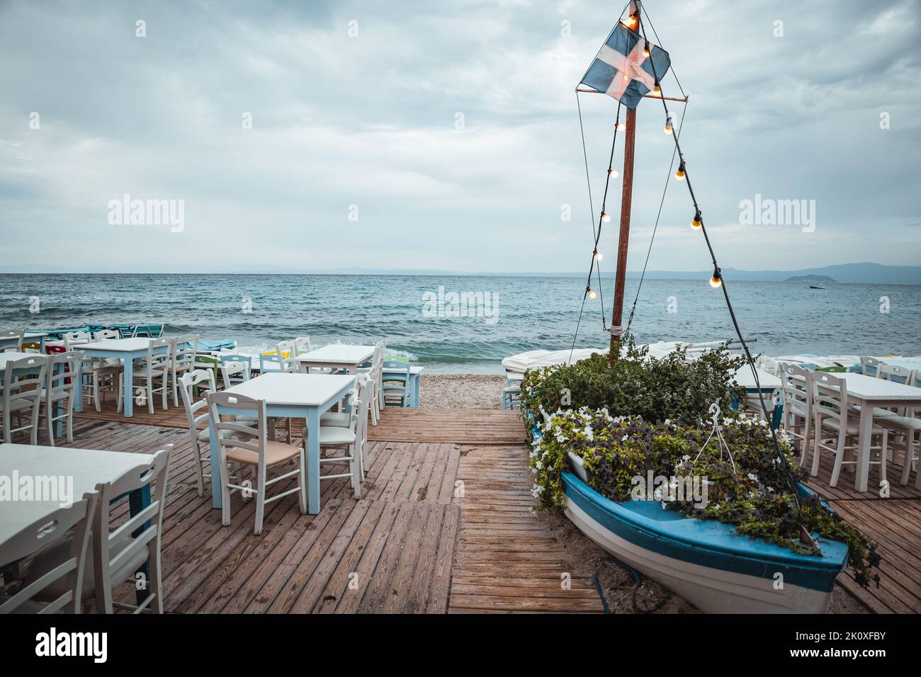 a blue boat decoration on a beach cafe Stock Photo - Alamy