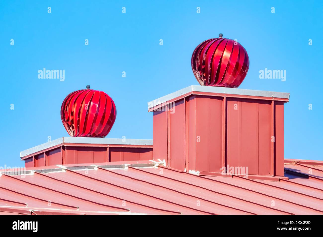 Two red colored turbine vents on the roof, on a sunny day Stock Photo ...