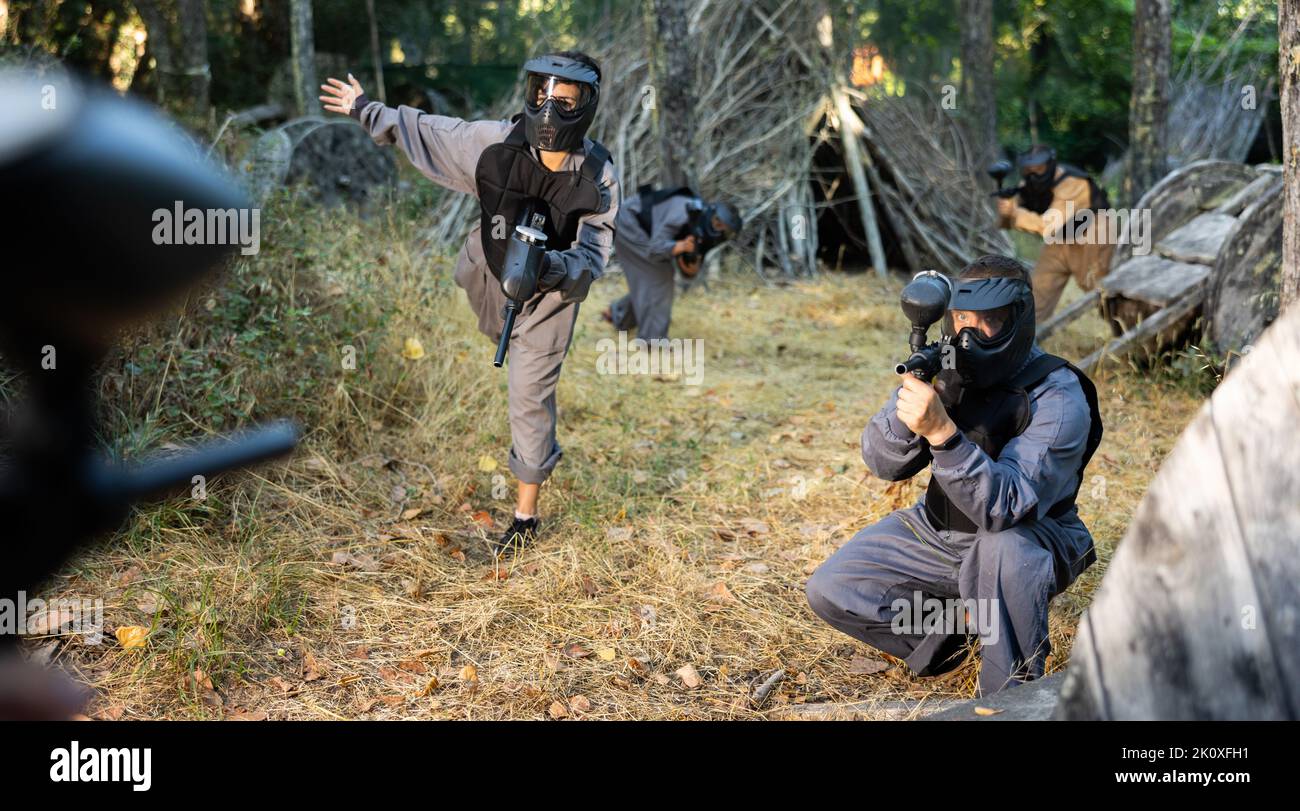 Teams facing on battlefield in outdoor paintball arena during match ...