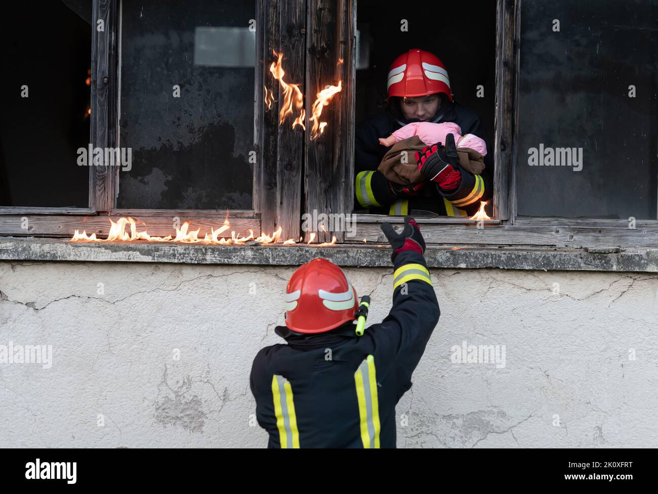Firefighter hero carrying baby girl out from burning building area from ...