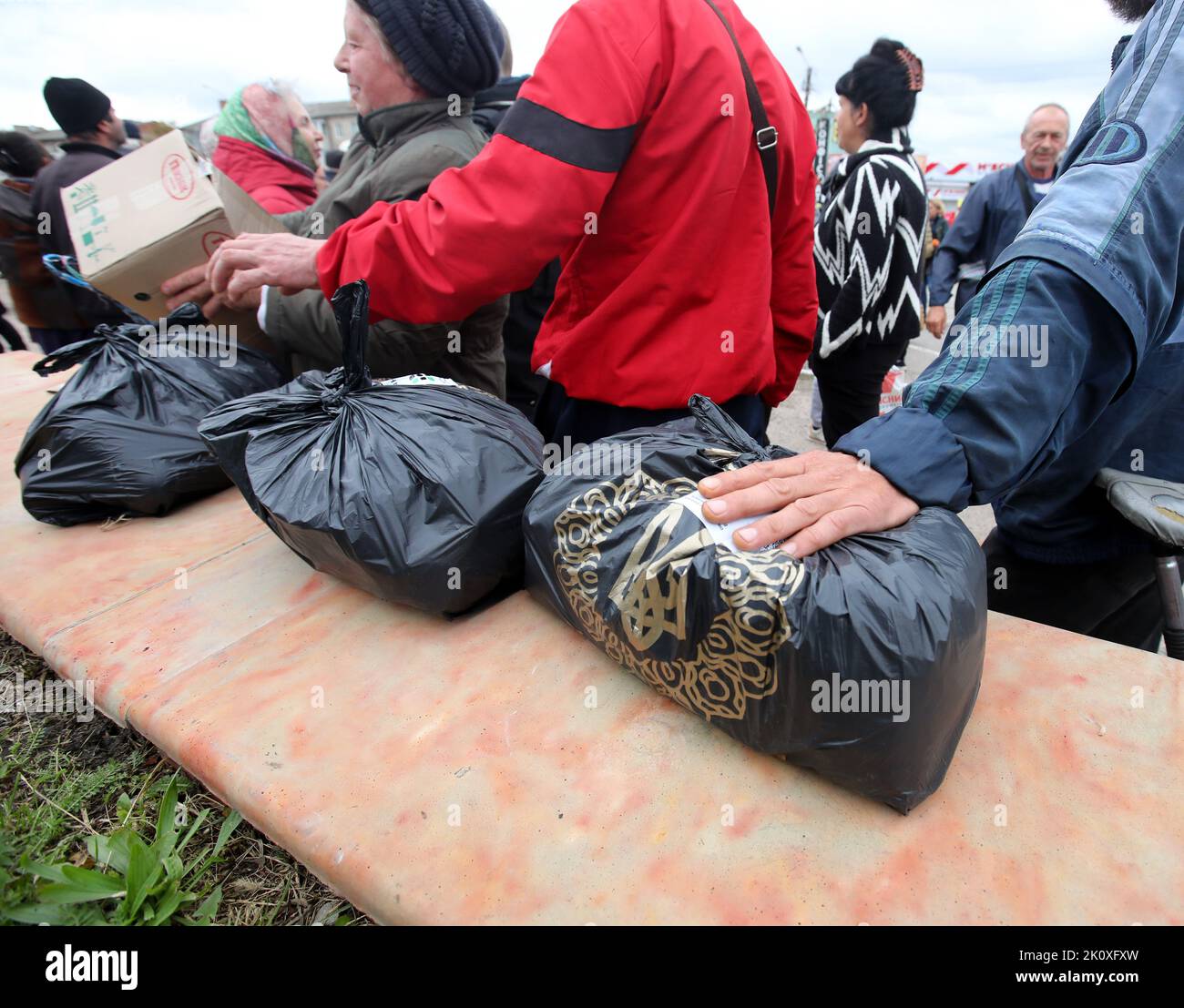 BALAKLIIA, UKRAINE - SEPTEMBER 13, 2022 - Local residents receive humanitarian aid kits for the ...