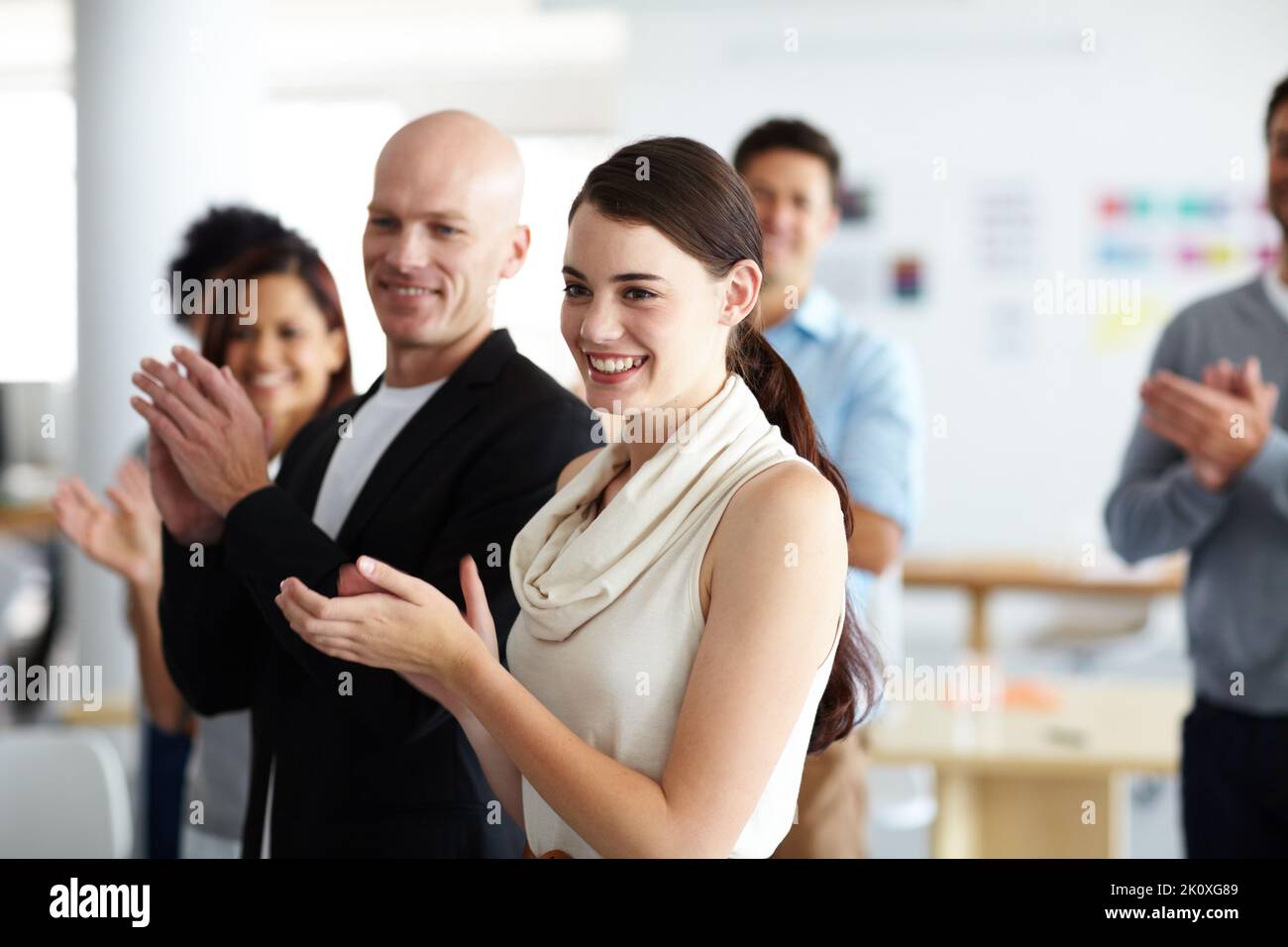 Applauding their success. A group of colleagues clapping during a ...
