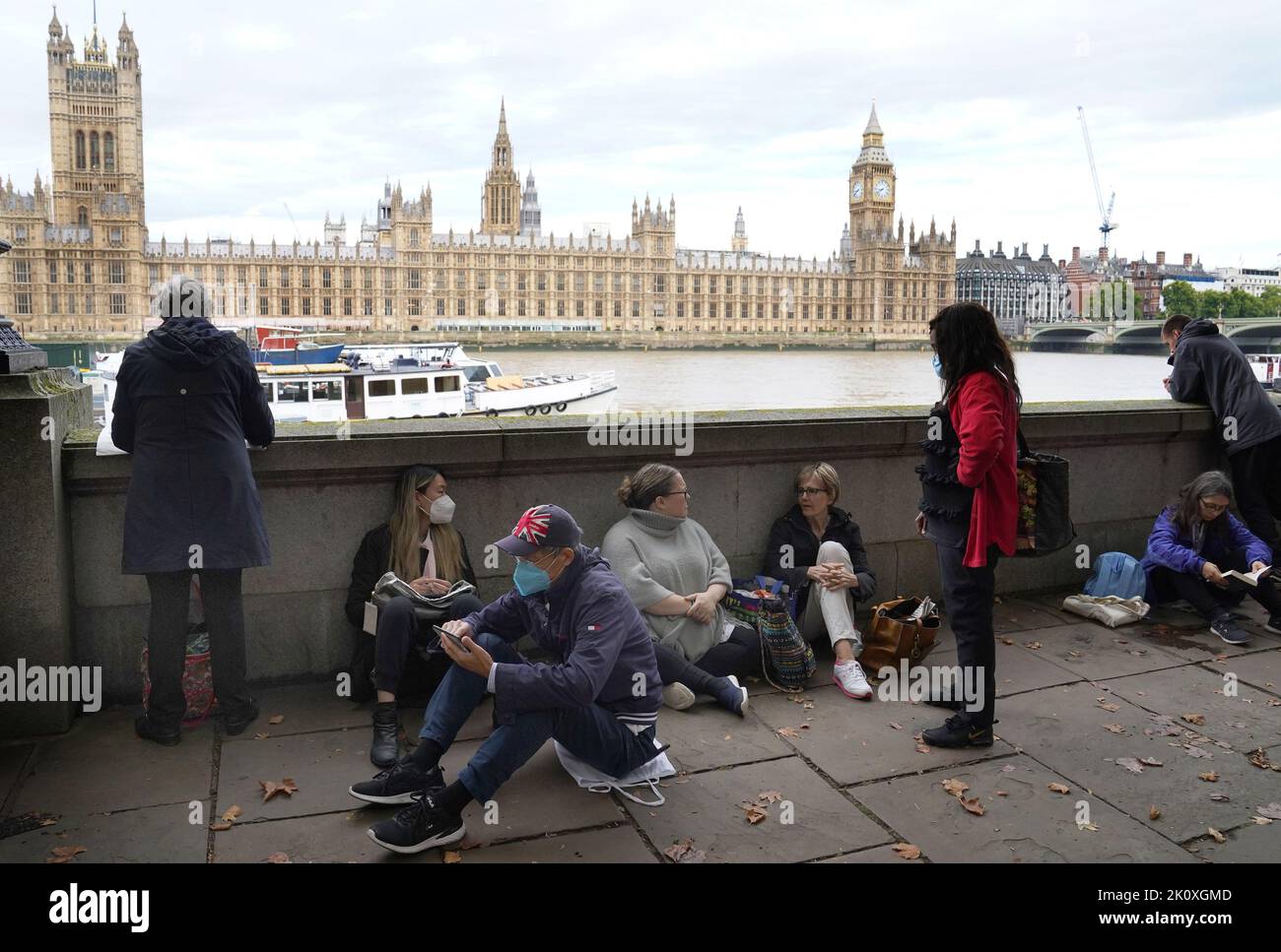 Members of the public join the queue on the South Bank, as they wait to ...