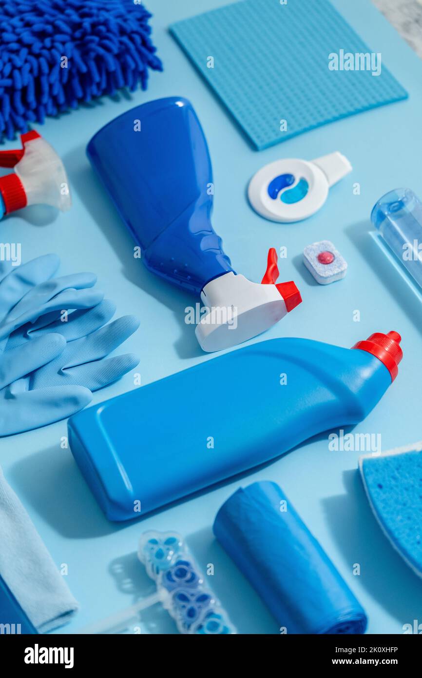 Colorful cleaning products on plain blue background. Housecleaning ...