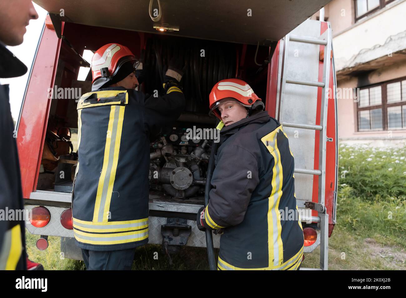 Group of fire fighters standing confident after a well done rescue ...