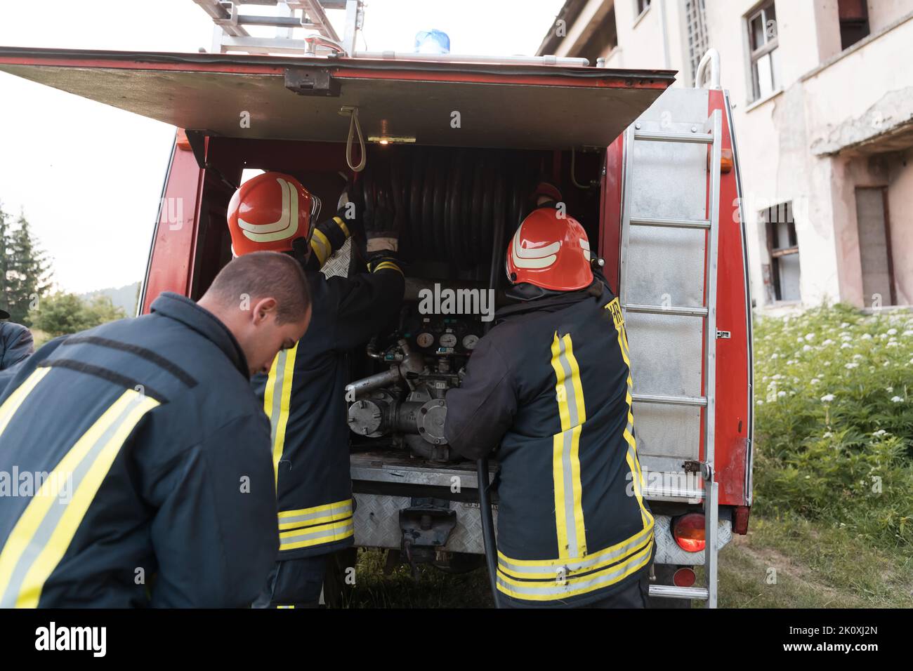Group of fire fighters standing confident after a well done rescue ...