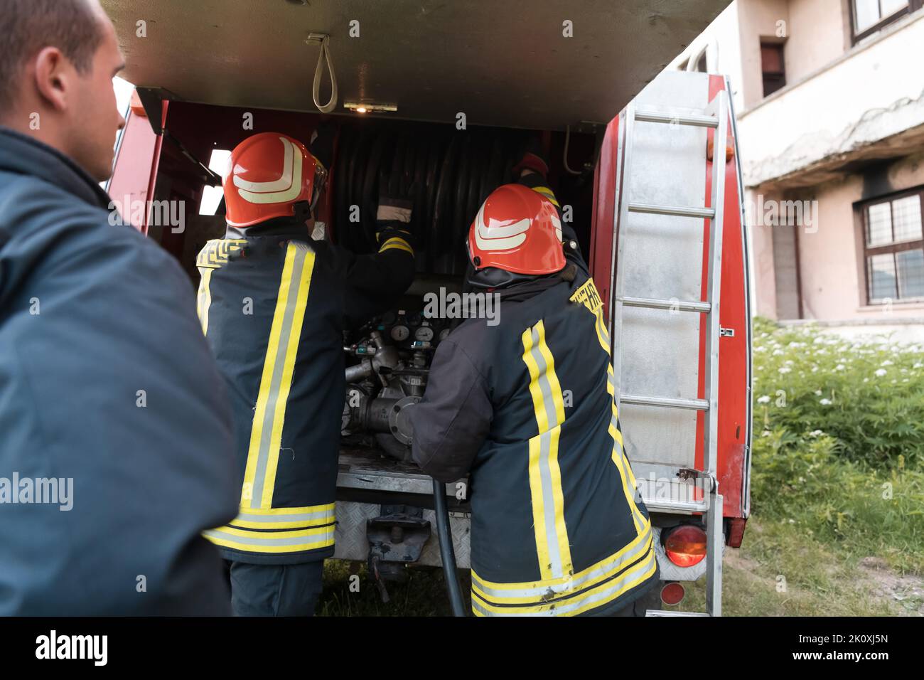 Group of fire fighters standing confident after a well done rescue ...