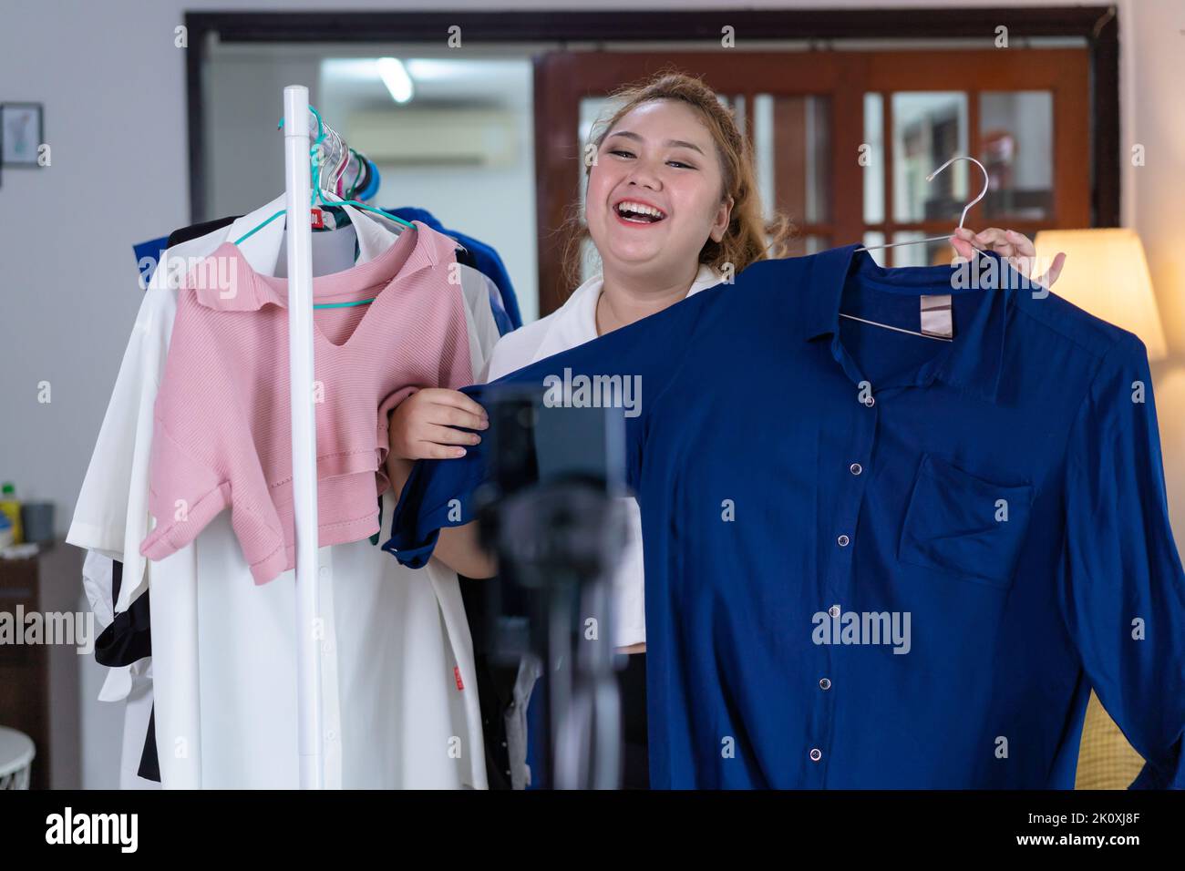 Young Asian plus size woman streaming live on social media to sell a ...