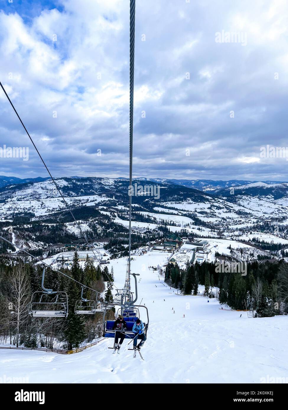 Bukovel Ukraine - February 2022 People going on Ski Lift snowy mountain ...