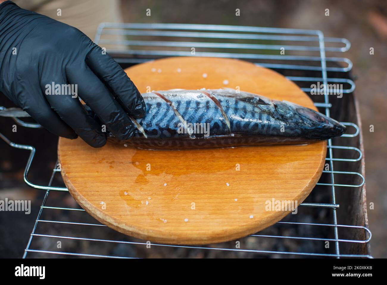 Grilled mackerel fish, top view. The process of cooking fish outdoors ...