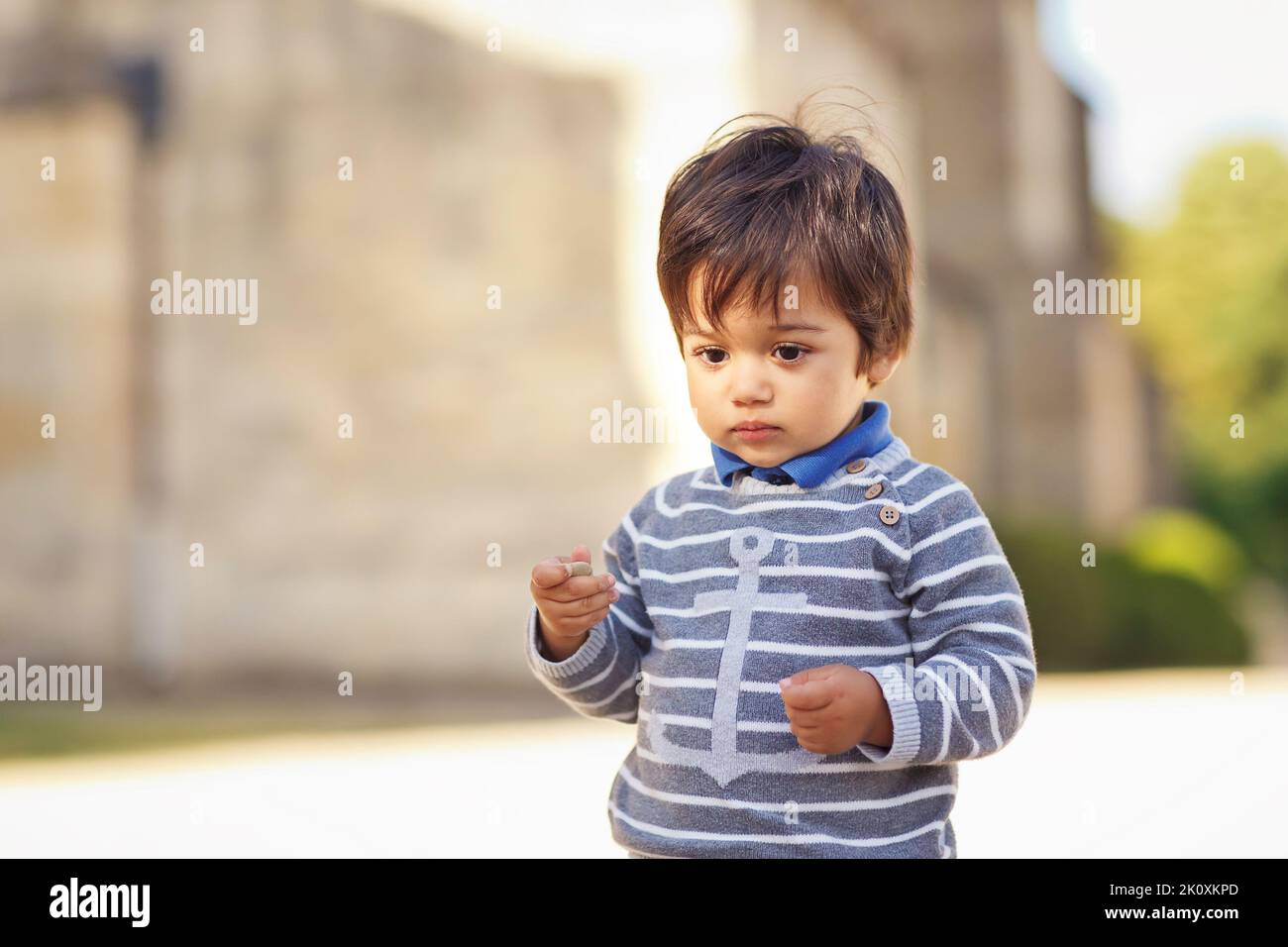 Portrait of a little eastern handsome baby boy playing outdoor in the ...