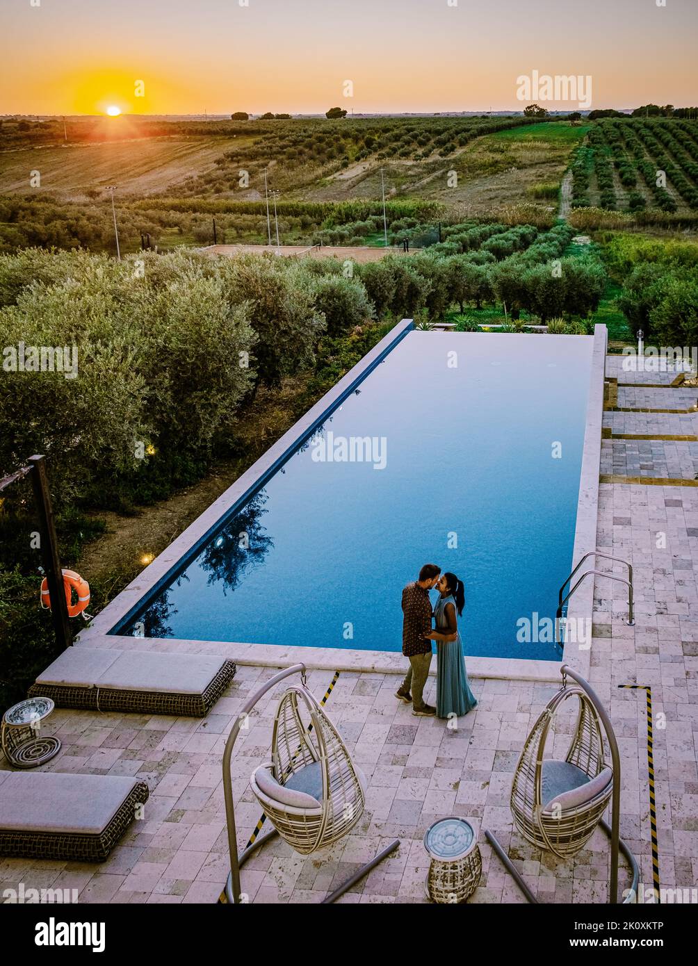 couple on vacation at luxury resort in Sicily during sunset by the ...