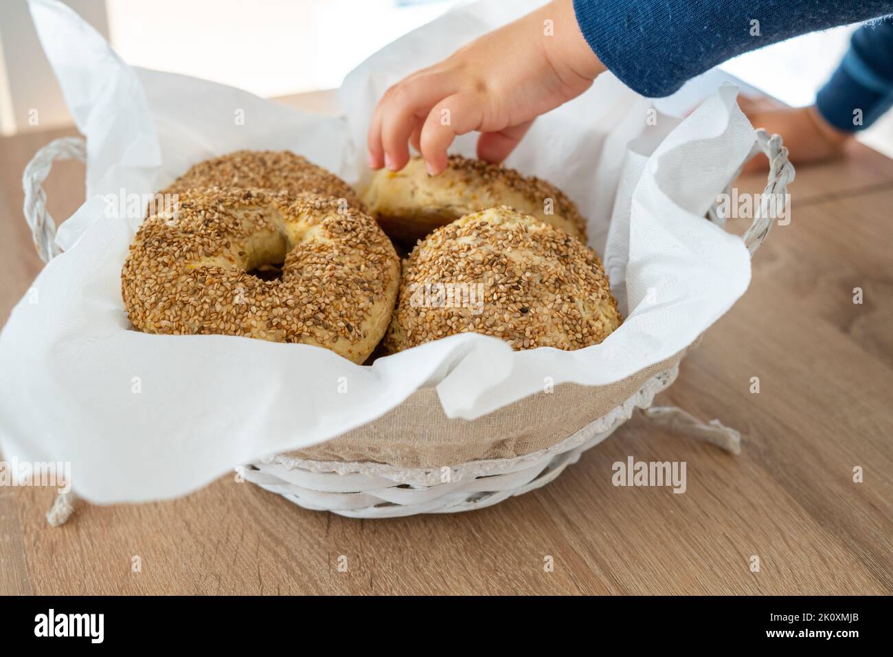 The child takes the bread from the bowl Stock Photo - Alamy