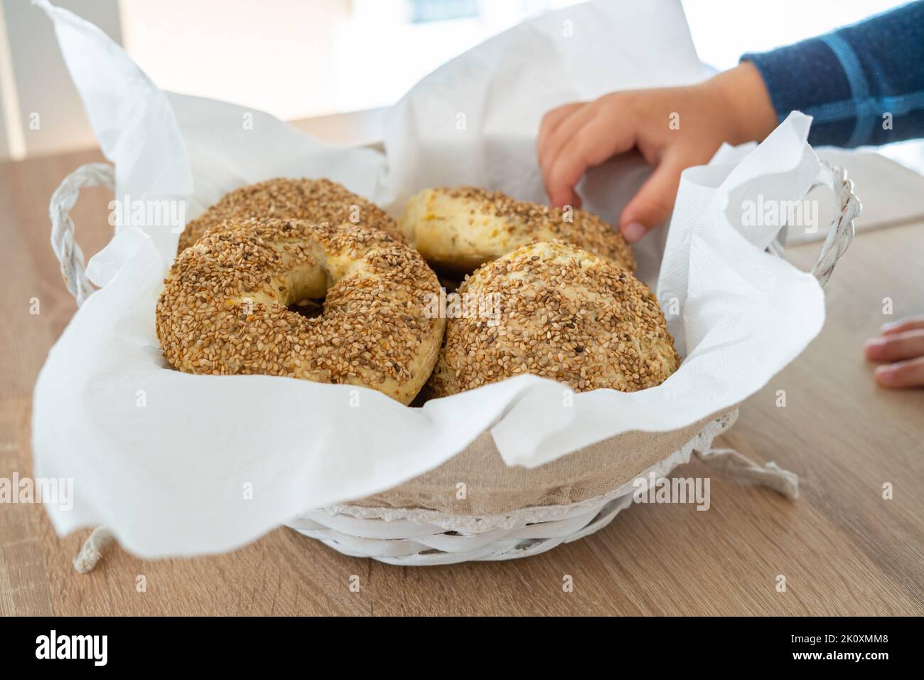 A child takes the bread from the bowl Stock Photo - Alamy