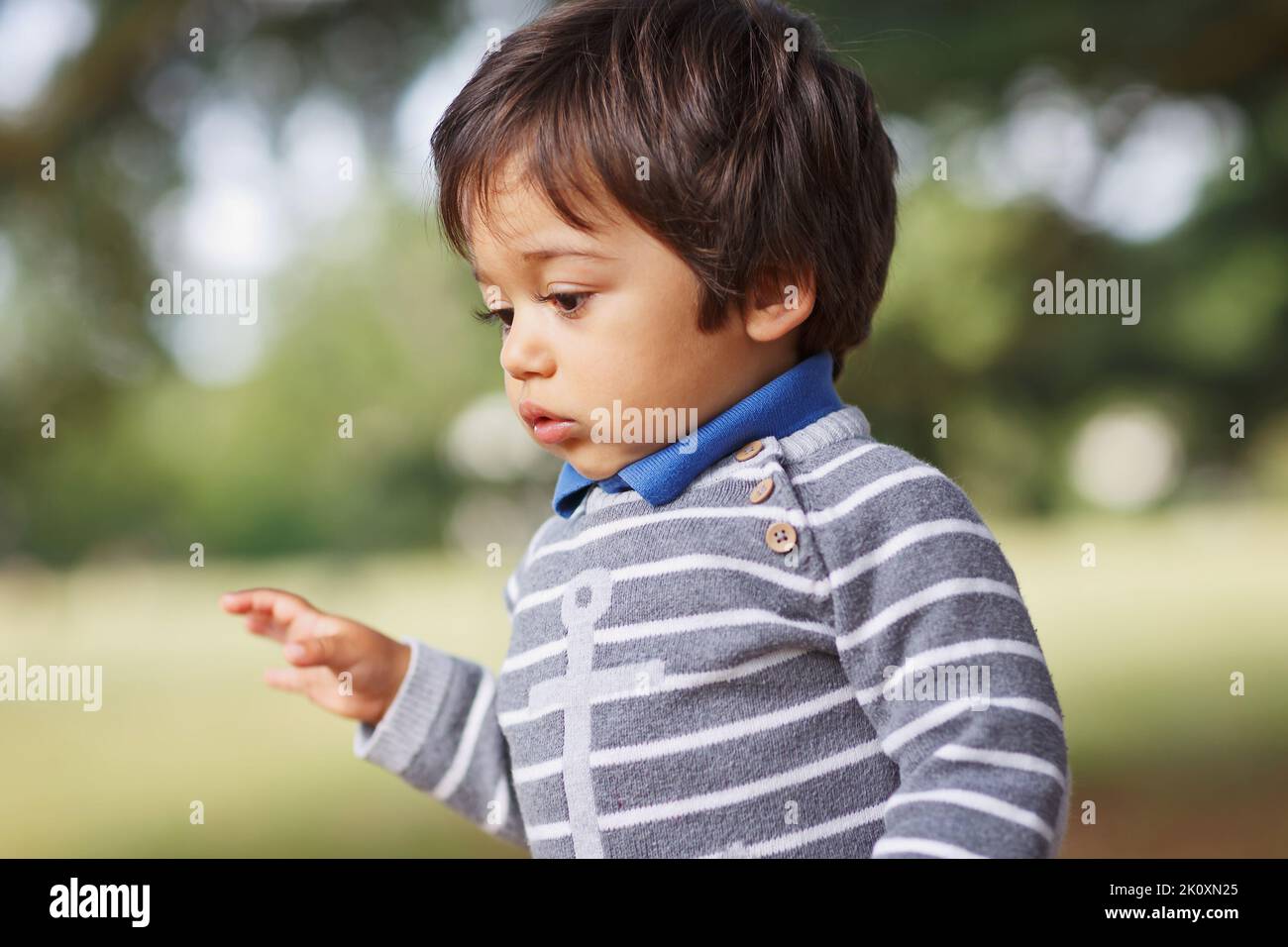 Portrait of a little eastern handsome baby boy playing outdoor in the ...