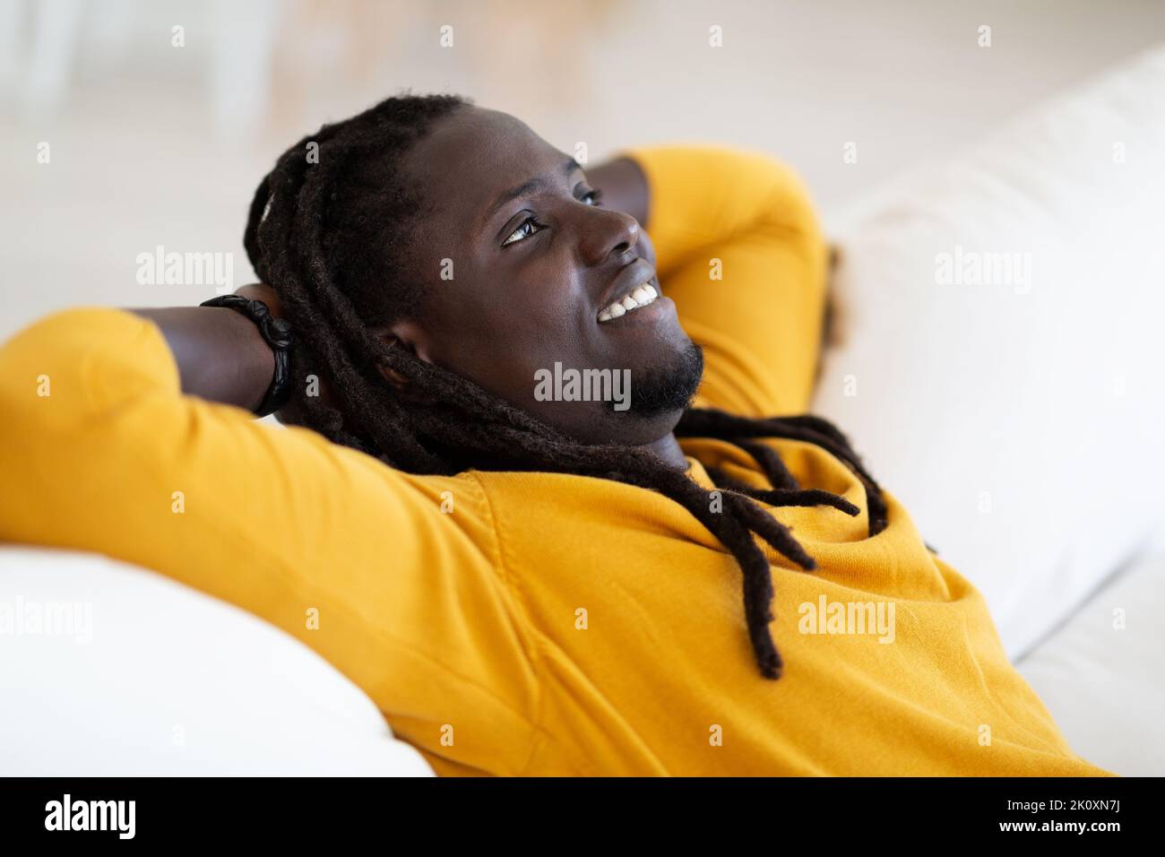 Man daydreaming sitting on couch hi-res stock photography and images ...