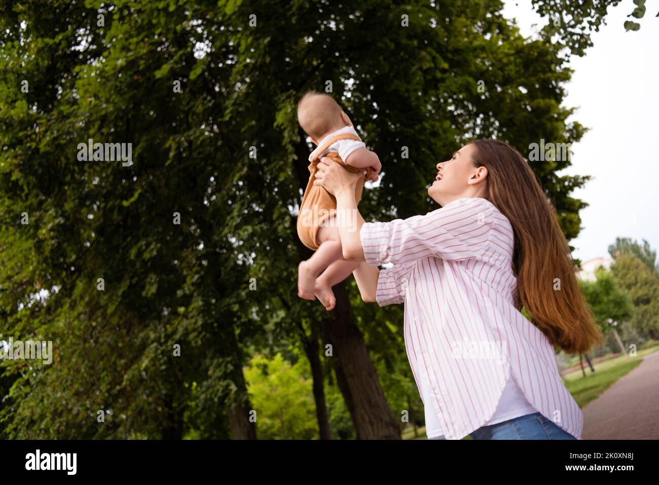 Photo of pretty adorable mom small daughter wear casual outfits playing ...