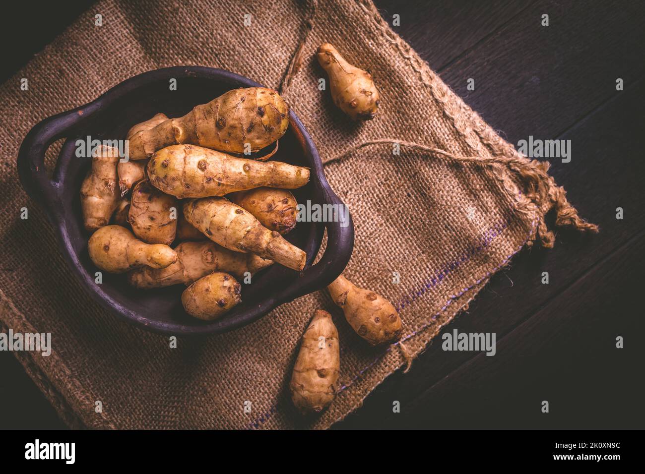 Raw jerusalem artichoke. Topinambur, vegetable root in bowl Stock Photo ...
