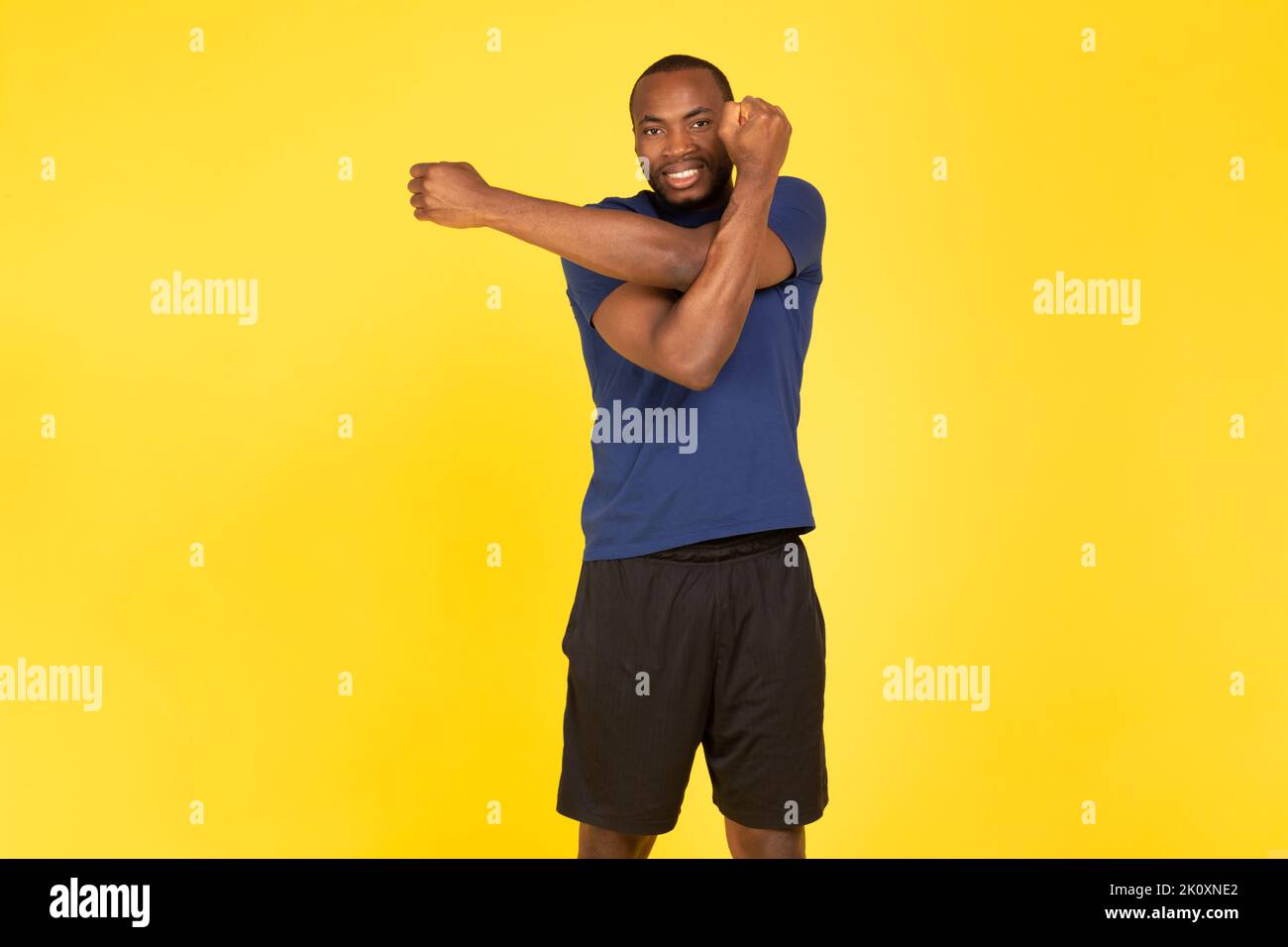 African Man Exercising Stretching Arms Having Fitness Workout, Yellow ...