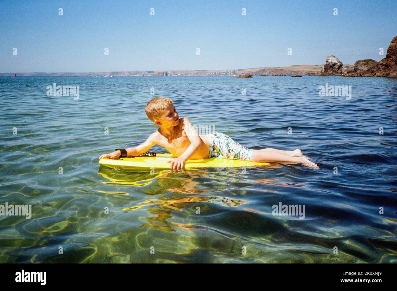 Five yer old boy bodyboarding, Hope Cove, Devon, England, united ...