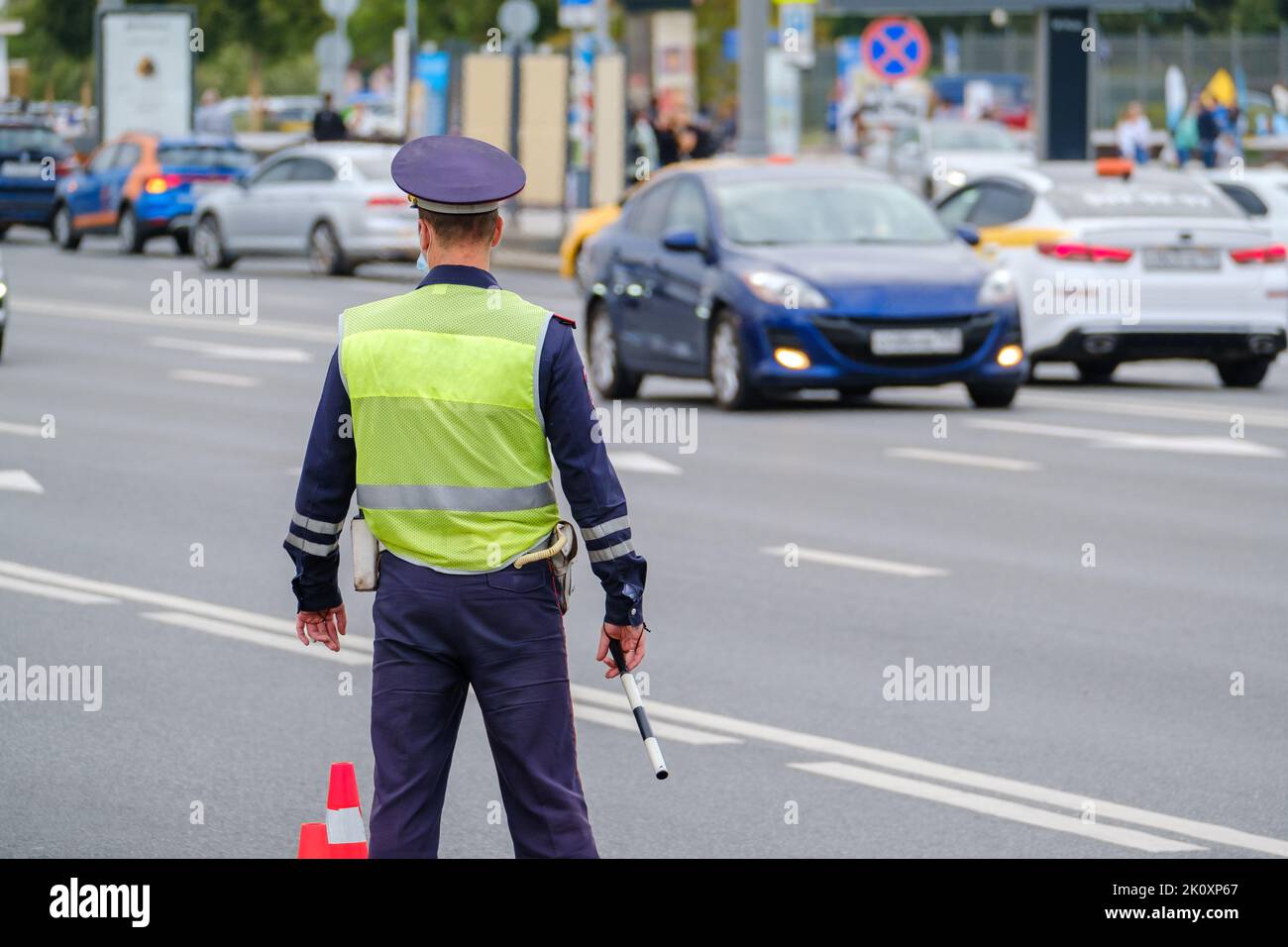 Back view of anonymous man in traffic police uniform and safety vest ...