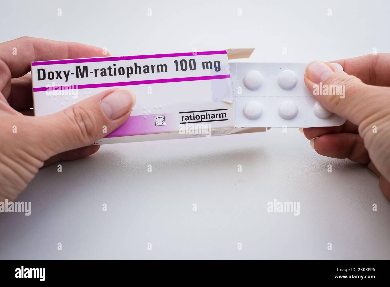 Woman taking Doxy-M-ratiopharm tablets by Ratiopharm for treating tick ...