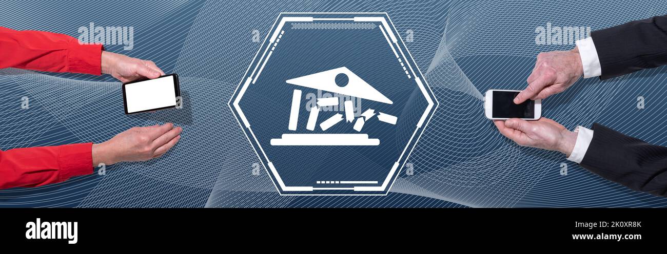 Top view of hands using mobile phone with symbol of economic collapse ...