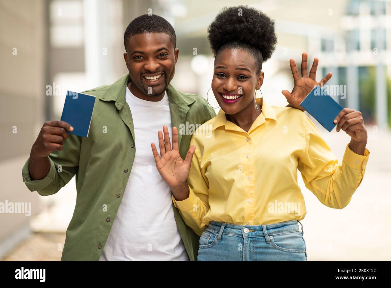 Black Tourists Couple Waving Hello Posing Holding Passports At Airport ...