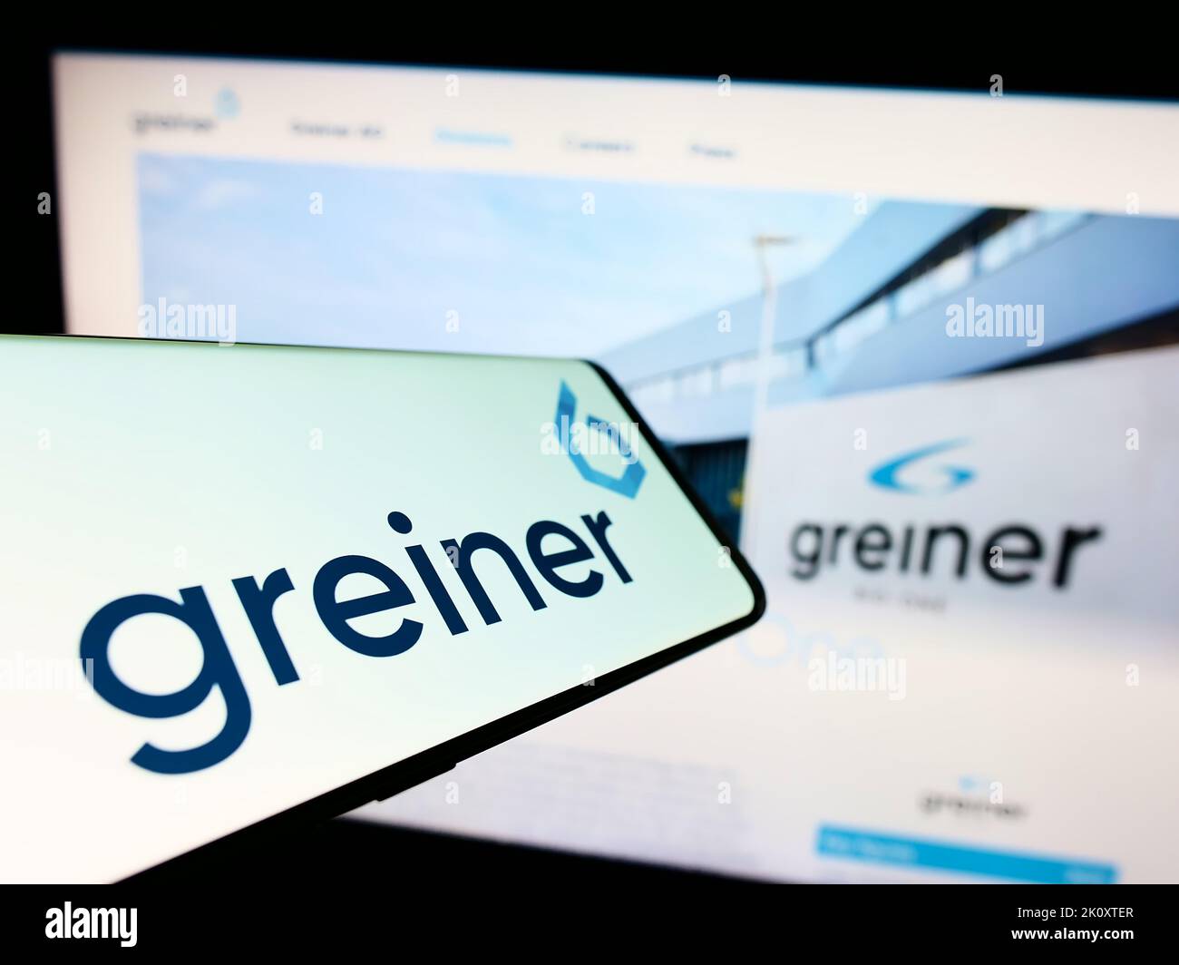 Smartphone with logo of Austrian plastics company Greiner AG on screen ...