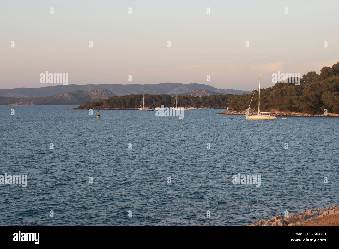 A display of seascape with sailing boats around a bay Stock Photo - Alamy