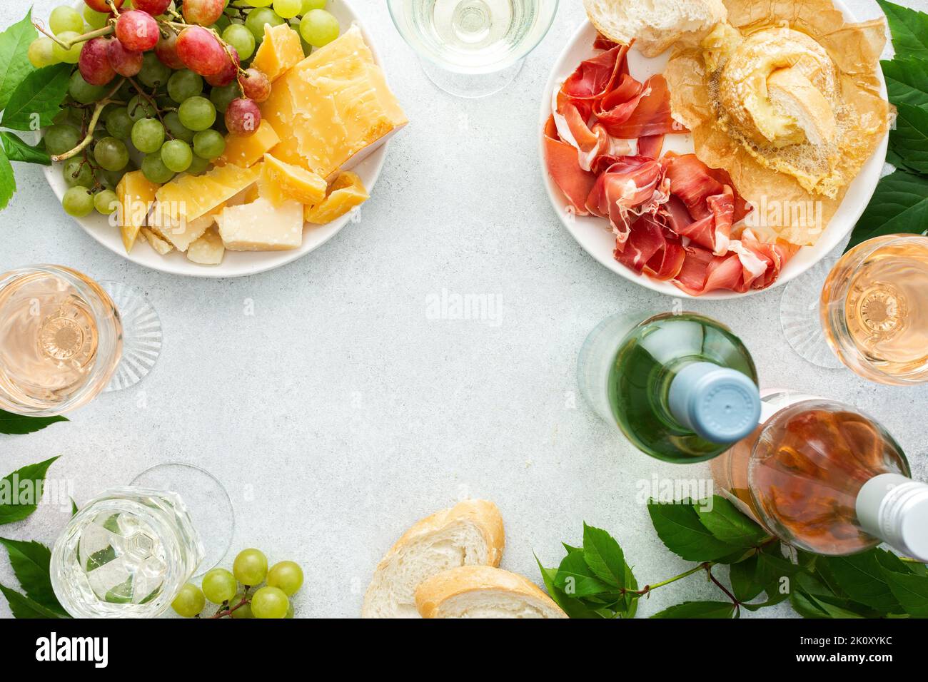 Top view of table with rose and white wine in glasses, plates with ...