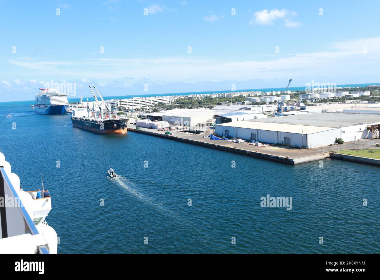 Large red Bulk ship / A coal ship docking outside big power station ...