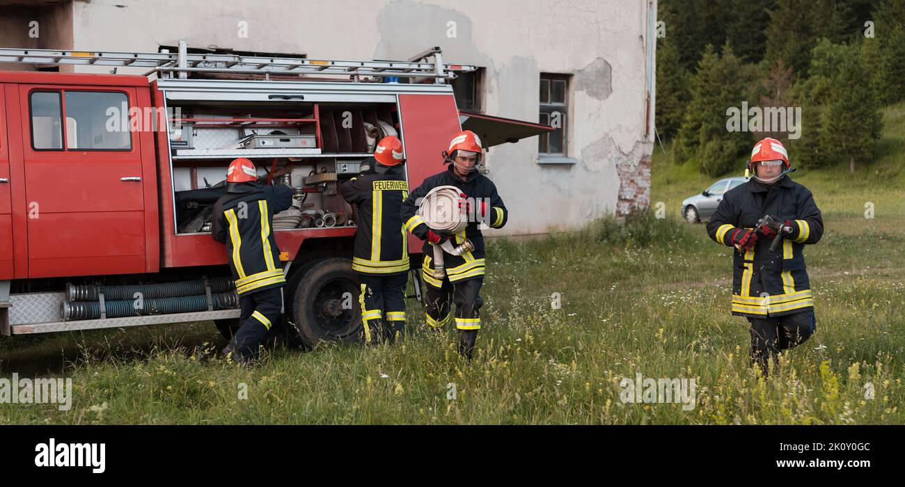Group of fire fighters standing confident after a well done rescue ...