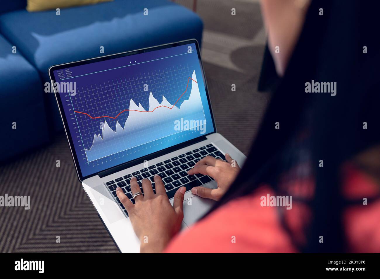 Biracial businesswoman using laptop with graphs on screen. Business ...