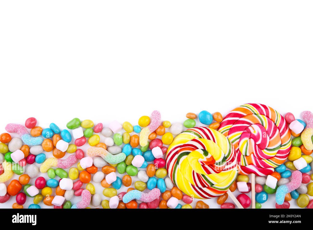 Colorful lollipops and different colored round candy isolated on white ...